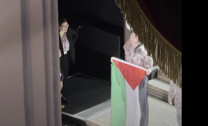 Cast Member Unfurls Flag During Opera's Curtain Call